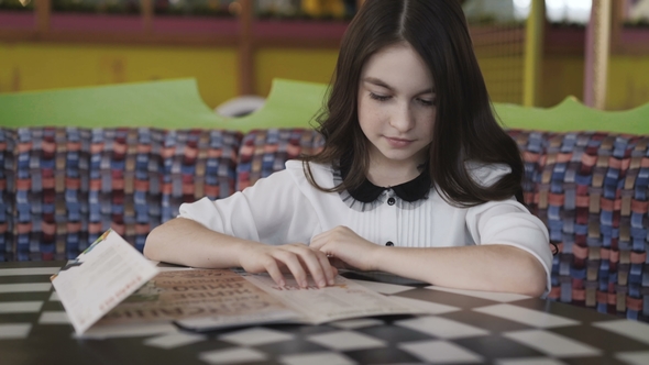 Pretty Girl Reading the Menu and Making an Order, Stock Footage | VideoHive