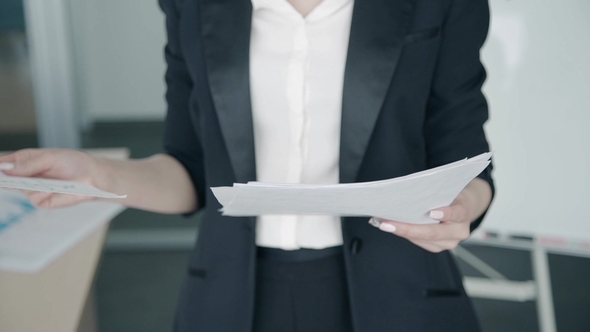 of Businesswoman Checking Paper Report Standing in the Office., Stock ...