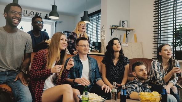 Mixed Race Friends Watching Popular TV Show. Medium Shot. . Singing ...