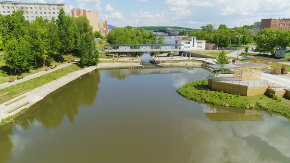 River Flows Across City and Surrounded with Green Plants, Stock Footage