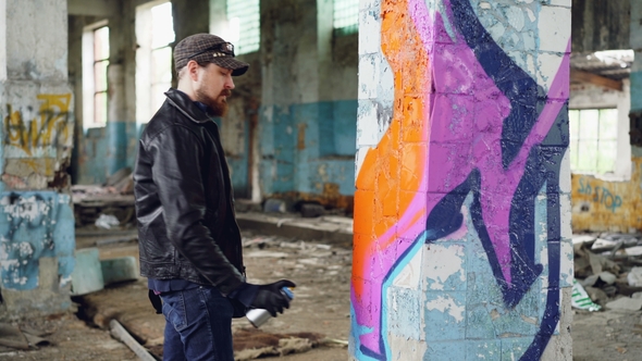 Handsome Bearded Guy Graffiti Artist Is Painting with Spray Paint ...