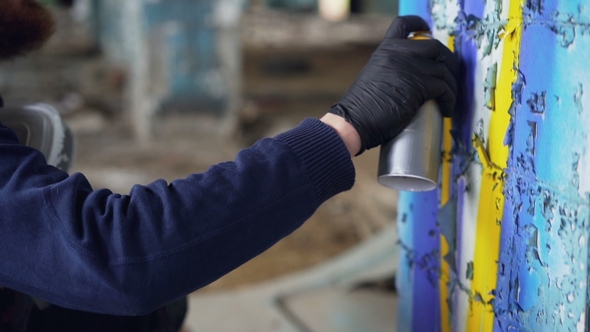 Graffiti Painter Is Squatting Near Column in Old Empty Building and ...