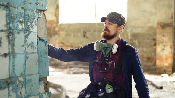Serious Bearded Guy Is Concentrated on Painting Graffiti on Old Dirty ...
