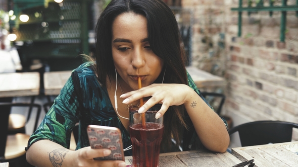 Young Woman Sipping a Cold Drink, Stock Footage | VideoHive