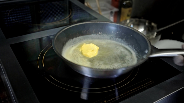 Chef Melting a Chunk of Butter on a Frying Pan in a Restaurant, Stock ...