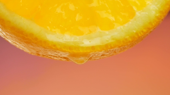 A Drop of Pure Water or Juice Dripping From a Slice of Orange, Stock ...