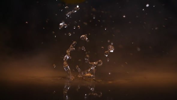 Lime Citrus Fruits Falling on Water Surface in Orange Light Spot and ...