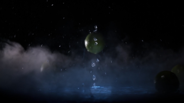 Lime Fruits Falling on Water Surface in Blue Light Spot and Cold Fog ...