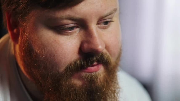 Calm Fat Man Looks at the TV-set. Portrait of a Bearded Man Who Has ...