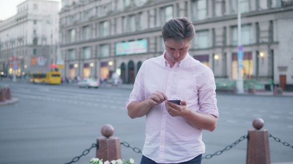 A Young Man Uses a Mobile Phone in the City., Stock Footage | VideoHive