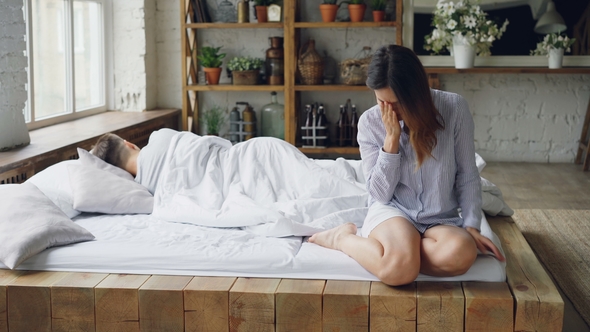 Sad Woman Is Sitting on Bed and Crying After Fight with Her Boyfriend ...