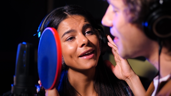 Two Young Singers Performing Their Song in Record Studio. Professional ...