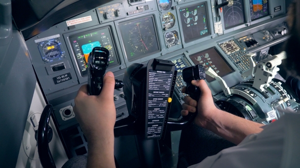 An Airman Is Managing a Control Wheel in a Plane's Cockpit, Stock Footage