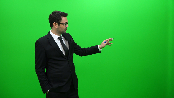Businessman Presenting in Front of a Green Screen. Left Side., Stock ...
