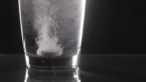 White Effervescent Tablet in Glass with Water on Table, Stock Footage