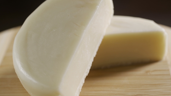 Cheese, Cut Into Half on a Wooden Plate, Stock Footage | VideoHive