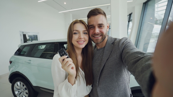 Attractive Young Couple Is Taking Selfie with Car Keys in Modern Motor ...