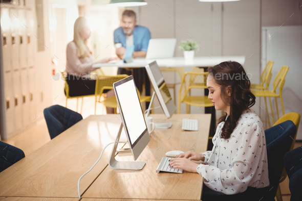 Female executive working on computer in office Stock Photo by ...