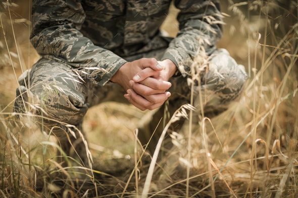 Military soldier crouching in grass Stock Photo by Wavebreakmedia ...