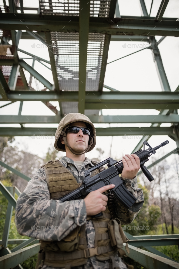 Military soldier guarding with a rifle Stock Photo by Wavebreakmedia