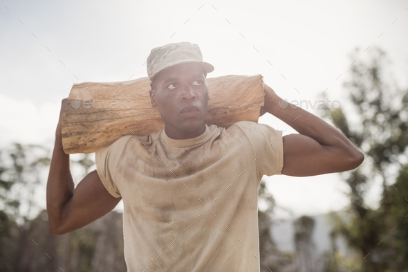 Military soldier carrying a tree log during obstacle course Stock Photo ...
