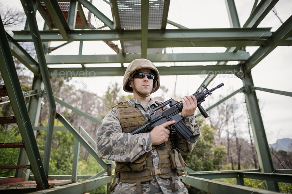 Military soldier guarding with a rifle Stock Photo by Wavebreakmedia