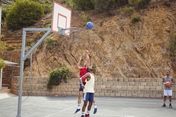 Basketball players playing in basketball court Stock Photo by ...