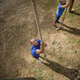 Fit person climbing down the rope during obstacle course Stock Photo by ...