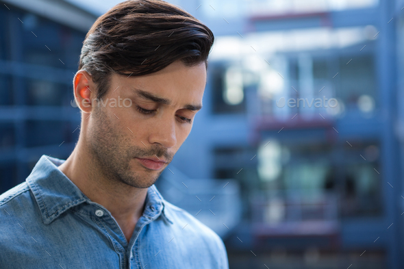 Handsome man looking down Stock Photo by Wavebreakmedia | PhotoDune