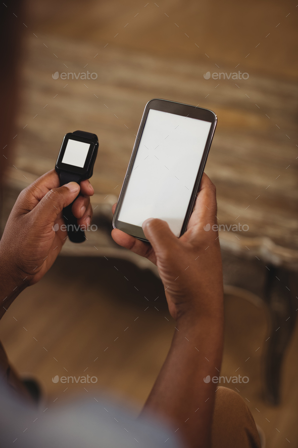 Man using smartwatch and smartphone Stock Photo by Wavebreakmedia ...
