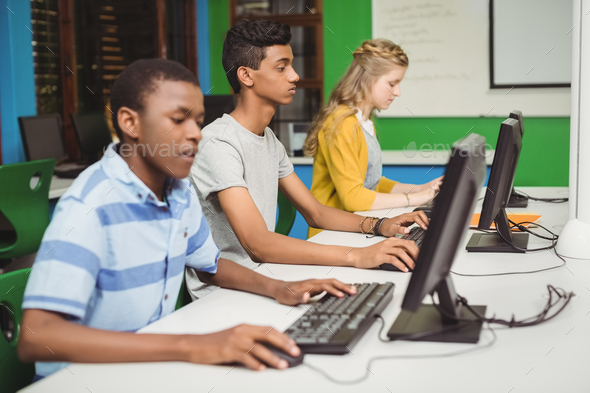 Students studying in computer classroom Stock Photo by Wavebreakmedia