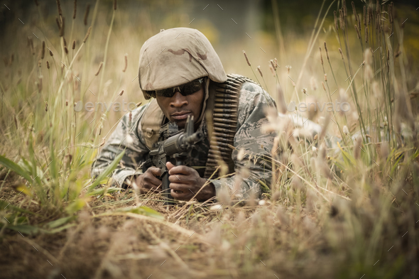 Military soldier guarding with a rifle Stock Photo by Wavebreakmedia