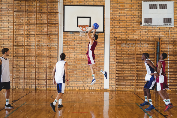 Basketball players playing in the court Stock Photo by Wavebreakmedia