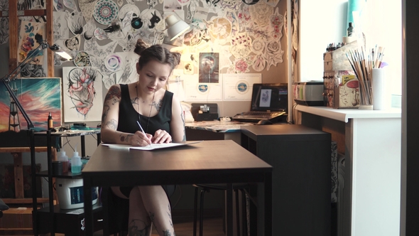 Tattoo Artist Makes a Sketch of Tattoo on Paper in a Home Studio, Stock ...