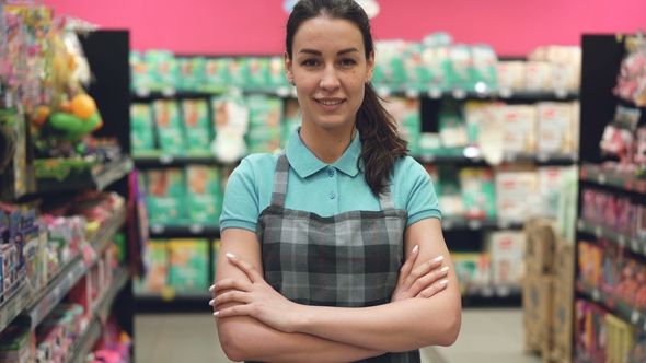 Portrait of Attractive Young Saleswoman in Apron Standing in ...