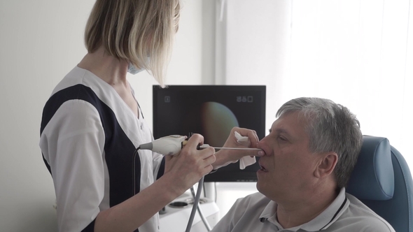 Doctor Check Nose of Elderly Man with ENT Telescope, Stock Footage
