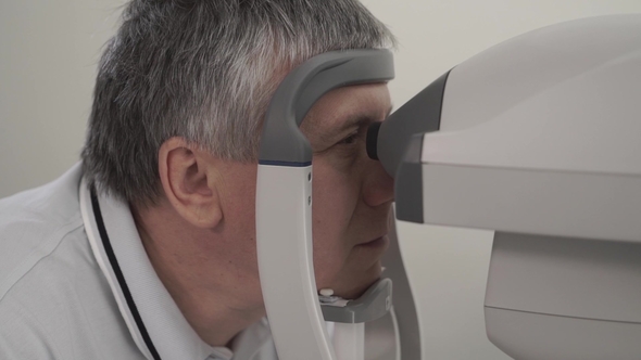 Man Check His Eyesight with Modern Optical Equipment, Stock Footage