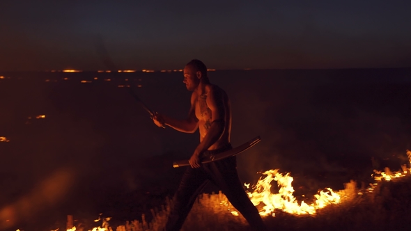 Military Man Shows Performance with Swords at Bonfires., Stock Footage