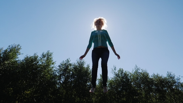 Jump High Toward the Sun. Women Jumping High on the Trampoline, Stock ...