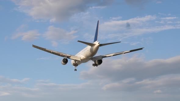 Airplane Is Landing Back View. Plane at Blue Sky Background with Clouds ...