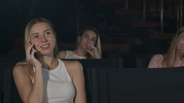 Young Woman on the Phone During Movie at the Cinema, Stock Footage