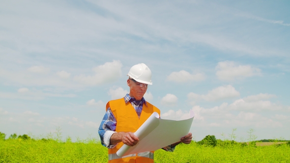 Engineer Analyzing Plan While Looking At Farm, Stock Footage | VideoHive