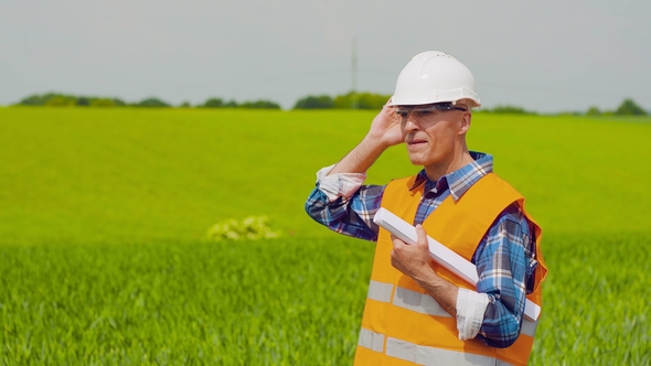 Engineer Analyzing Plan While Looking At Farm, Stock Footage | VideoHive