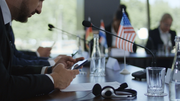 Summit Member Using Phone at Table, Stock Footage | VideoHive