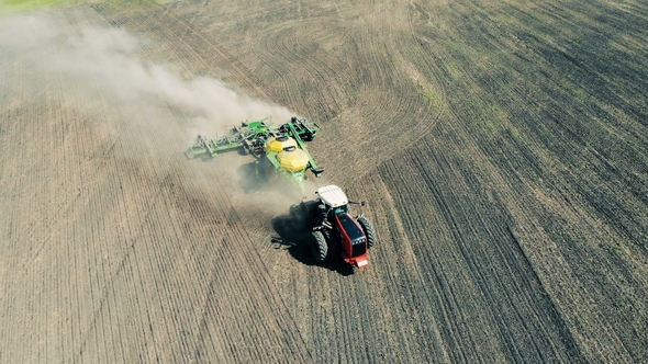 Aerial View of an Agriculture Tractor Moving Across Field, Stock Footage