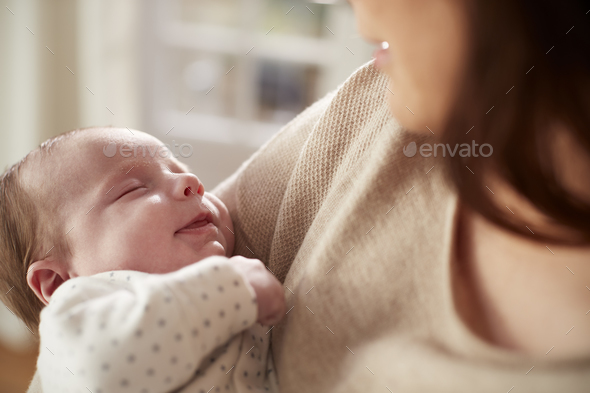 Close Up Of Sleeping Newborn Baby Being Held By Mother Stock Photo by ...