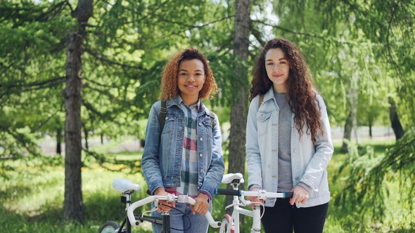 Portrait of Happy Young Women Caucasian and African American Standing ...