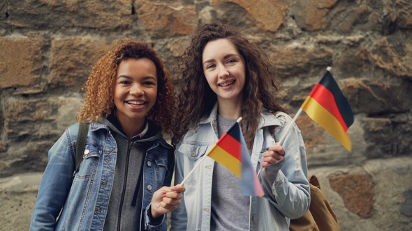 Portrait of Two Smiling Girls Friends Waving German Flags and Looking ...