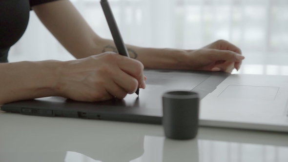 Female Hand Using Graphics Tablet on Table . Woman Working with Laptop ...