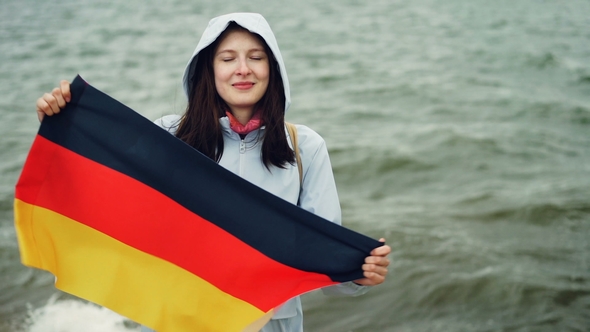 Portrait of Pretty German Woman Proud Citizen Holding Official Flag of ...